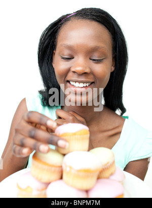 Delighted woman looking at cakes in the kitchen Stock Photo - Alamy