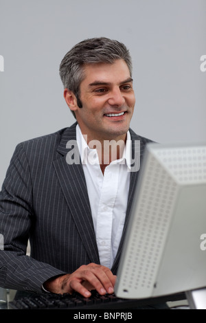 Male executive working on computer in office Stock Photo - Alamy