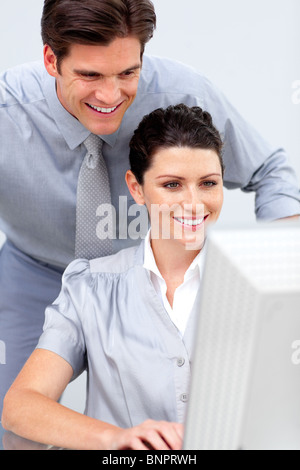 Confident business woman and her colleage working at a computer Stock ...