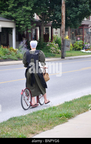 Amish girl riding scooter, Lancaster County, Pennsylvania, USA Stock ...