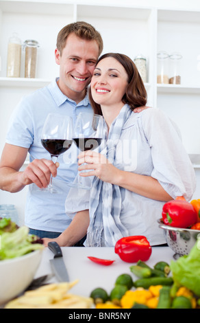 Smiling lovers with wine and vegetables Stock Photo - Alamy