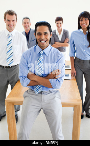 Business partners standing around a table Stock Photo - Alamy