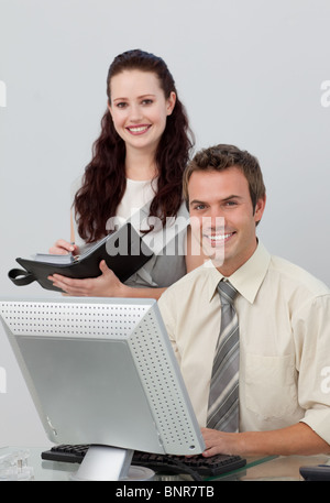 Charming manager checking her employee's work Stock Photo - Alamy