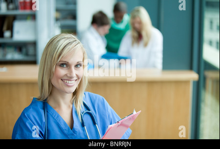 Pretty female surgeon with her team behind her Stock Photo - Alamy
