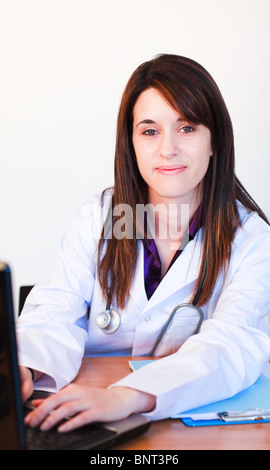 Brunette female doctor using laptop computer in hospital. Healthcare ...
