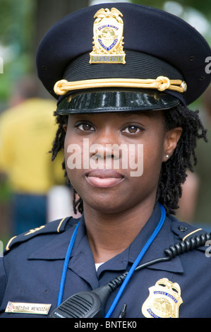 African-American female police officer blowing bubble gum on white ...