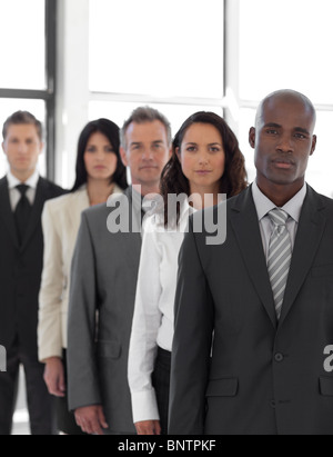 Positive elderly female boss in white shirt speaking on cellphone ...