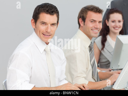 Beautiful business people are using computers while working in office ...