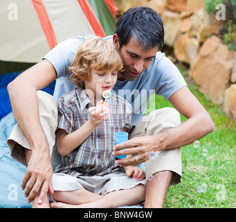 Adorable preteen boy blowing for make bubbles isolated on a over white ...