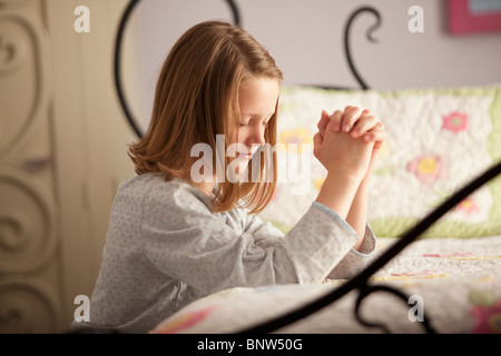 Young girl praying before bed time Stock Photo: 27083597 - Alamy