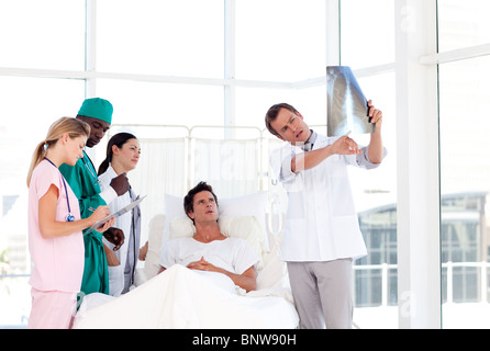 Young redhead doctor woman showing smartphone doing ok sign with ...