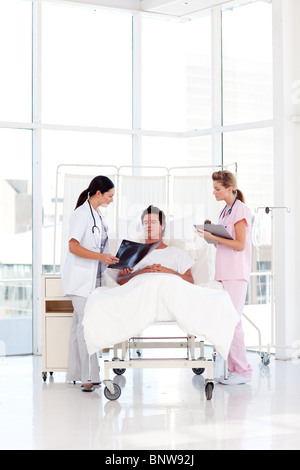 Young redhead doctor woman showing smartphone doing ok sign with ...