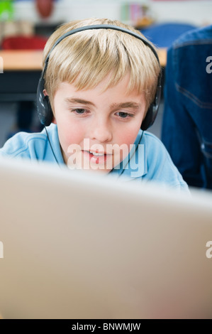 School Children use computers with headphones to learn language in ...
