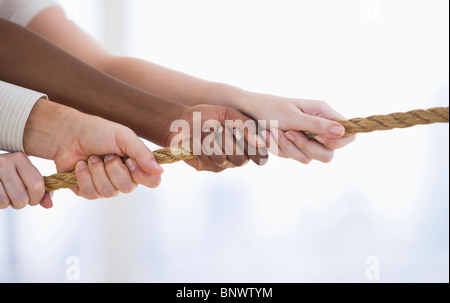 Group of woman hands pulling a rope competing with a man (selective ...