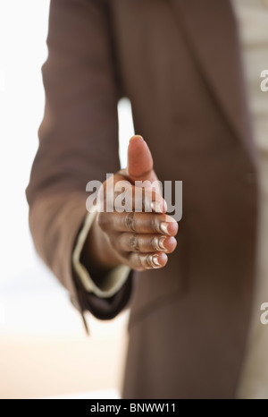 Hand extended for handshake Stock Photo - Alamy