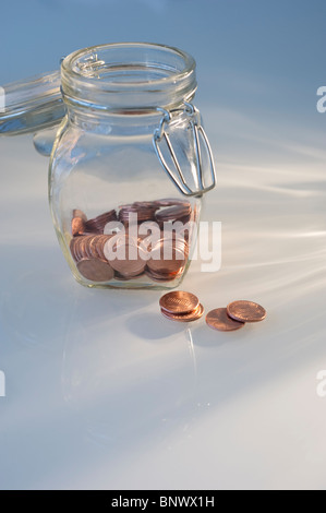 Glass jar of pennies Stock Photo - Alamy