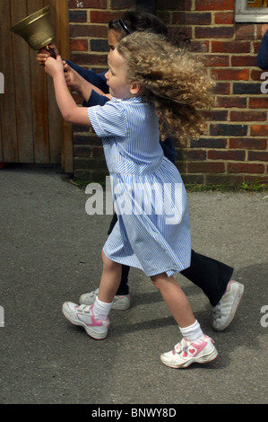 Primary school children ringing the bell in the playground Stock Photo ...