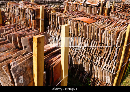 Stacks of reclaimed old traditional red clay roofing tiles - France ...