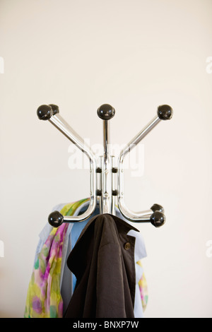 Coats and jackets hanging on a rack in a messy room Stock Photo - Alamy