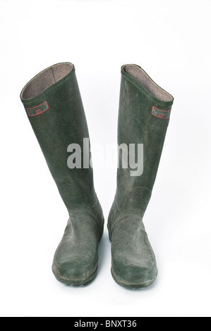 Old worn pair of Green Wellington (Wellies) boots on a concrete floor ...