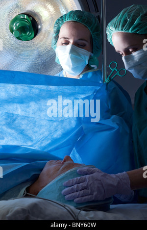 cropped image of surgeons operating patient abdomen in operating room ...