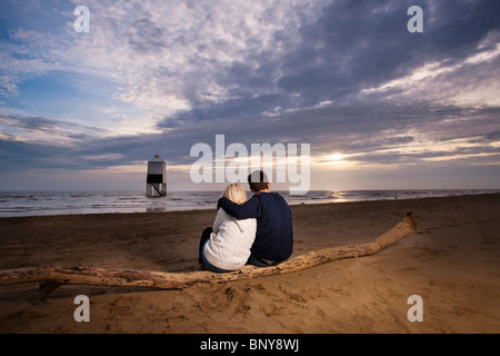 Couple watching the sunset Stock Photo - Alamy