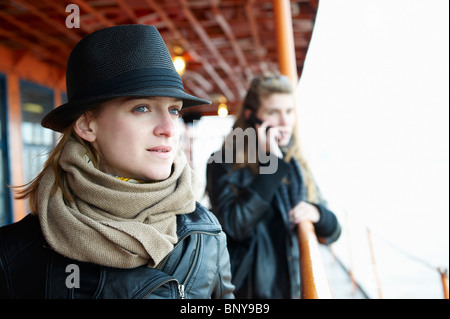 Caucasian woman on a boat in the ocean adjusts her goggles in ...