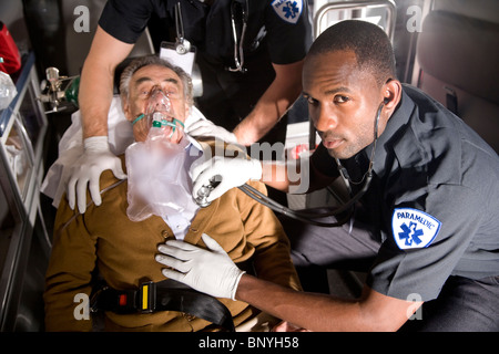Paramedics caring for elderly patient in ambulance Stock Photo - Alamy