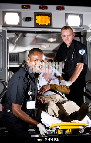 Paramedics caring for elderly patient in ambulance Stock Photo - Alamy