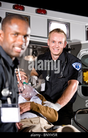 Paramedics caring for elderly patient in ambulance Stock Photo - Alamy