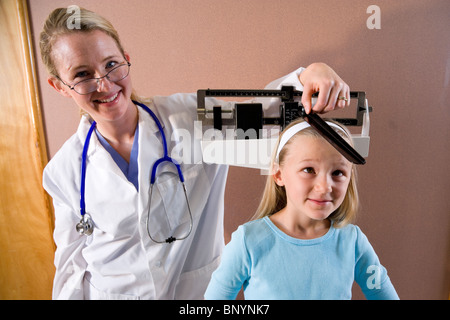 Annual checkup, doctor measuring child's height Stock Photo - Alamy