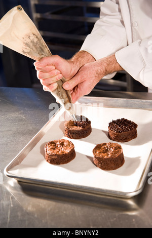 Decorating pastries, cropped Stock Photo - Alamy