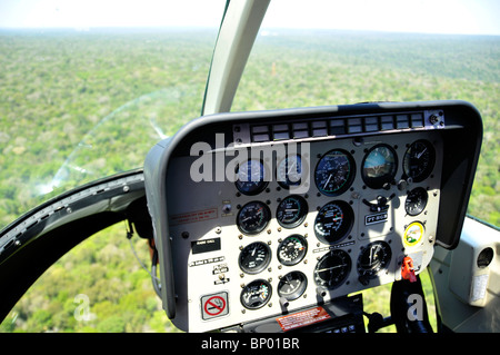 Dashboard of helicopter pilot view while flying above the clouds with a ...