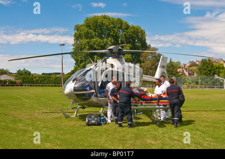 Rescue team carrying patient to Eurocopter EC135 air ambulance - Indre ...