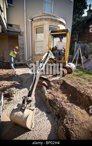 Digger preparing foundations with wet cement Stock Photo - Alamy