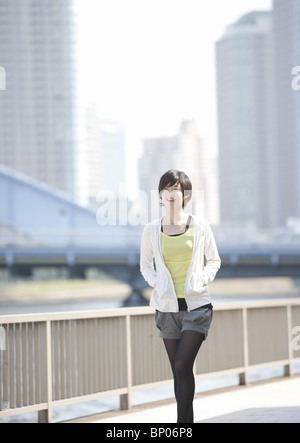 Japanese woman walking along the river Stock Photo - Alamy