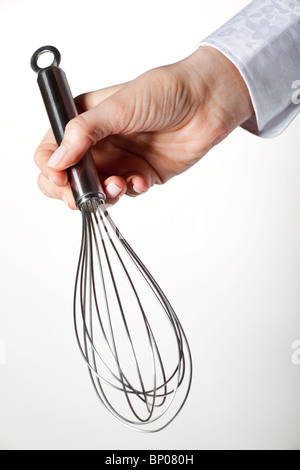 Woman holding metal whisk on light grey background, closeup Stock Photo ...