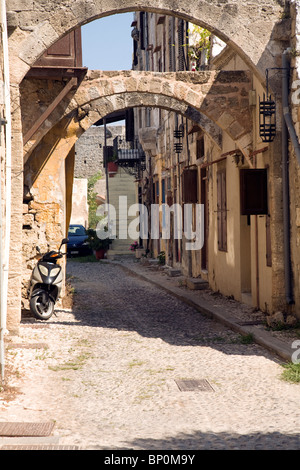 Tourism in Rhodes, Greece. Back view of traveler girl goes down the ...