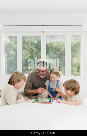 Family playing board game, Monopoly Stock Photo - Alamy