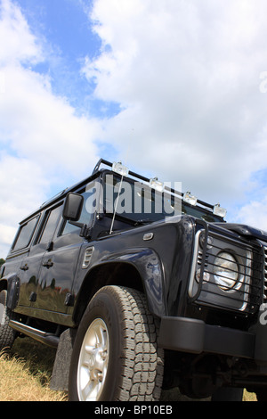 Black Land Rover Defender 110 long wheelbase parked on a gravel farm ...