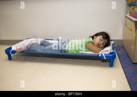 4 year old preschool girl sleeping on a cot during naptime Stock Photo ...