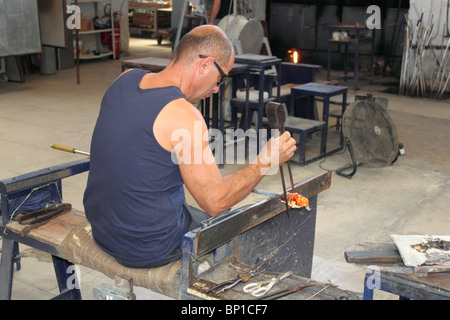 Man making glass figurines at the Mdina Glass factory, Ta Qali Crafts ...
