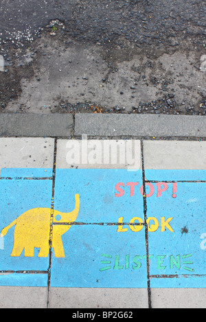 Stop - Look - Listen, children's road safety sign painted on pavement ...
