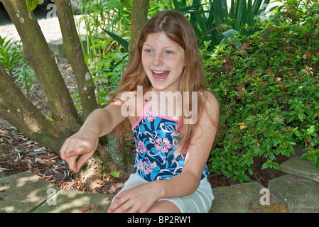 Photo portrait of excited girl pointing finger at blank space isolated ...