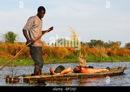 Local Bayei people in the tradiional mokoro dugout boat, Okavango Delta ...