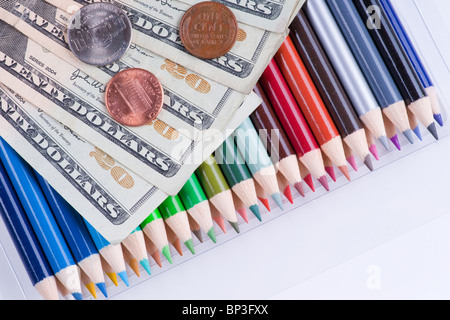 Box of color pencils with paper and coin money Stock Photo - Alamy