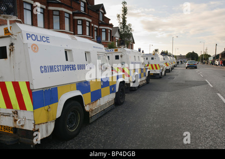 PSNI Police landrovers line up across a road to block it from a group ...