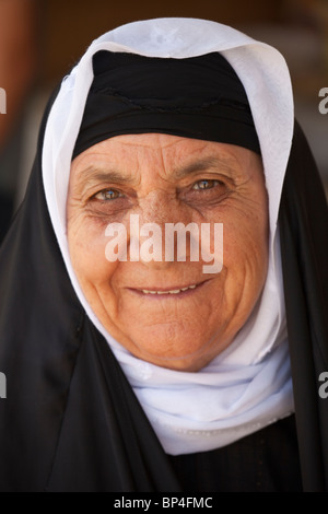 An smiling elderly Muslim woman wearing a embroidered hijab Stock Photo ...