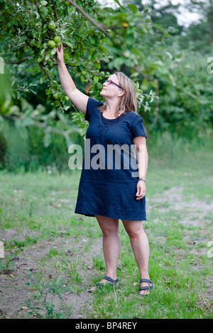 So much to choose from. An attractive young woman holding a bunch of ...