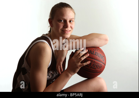 A tall high school girl's basketball player poses next to a toddler's ...